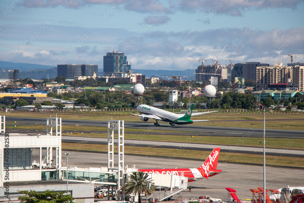 Aerial view of EVA Air Boeing 777-300ER taking off on runway near ...