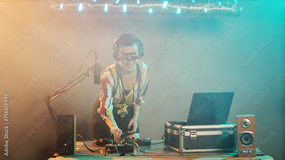 Cool funky DJ acting silly mixing with tongue out, fooling around in ...
