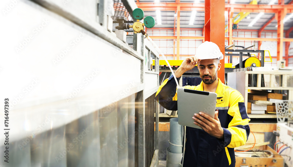 Factory safety : Male technician engineer wearing helmet holds tablet ...