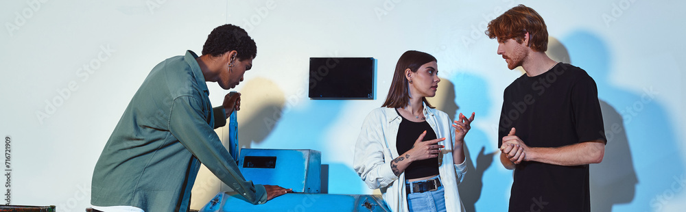 banner of interracial team talking during quest in escape room ...