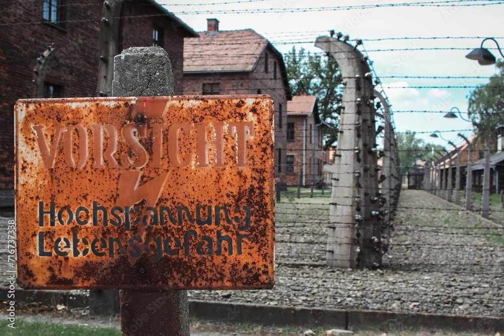 Concentration camp Auschwitz, Oswiecim with warning sign. Barbed wire ...