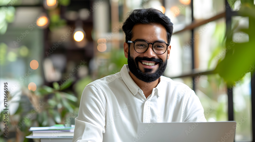 Businessman with a beard and a smile in a contemporary office lobby ...