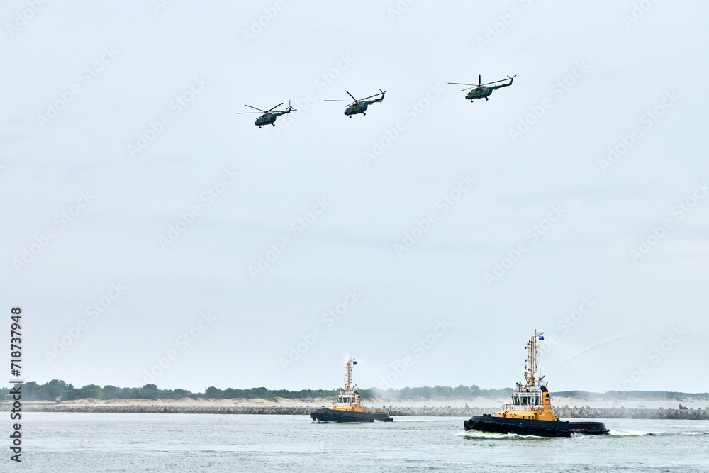 Three Russian military helicopters armed with missiles flying ashore ...