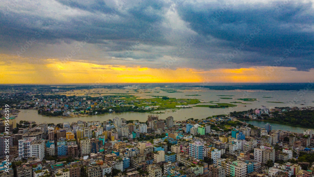 Aerial urban Sunset in a dense city by the water . Dhaka is the capital ...