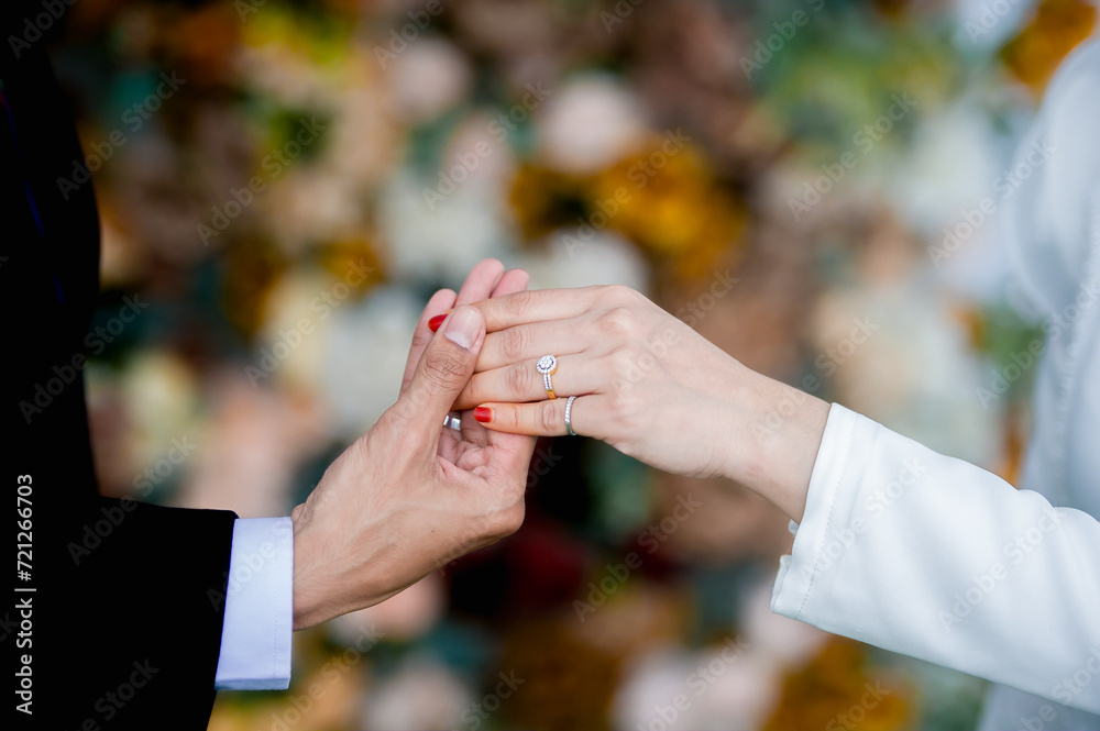 muslim groom in white dress wear wedding rings to left ring finger of ...