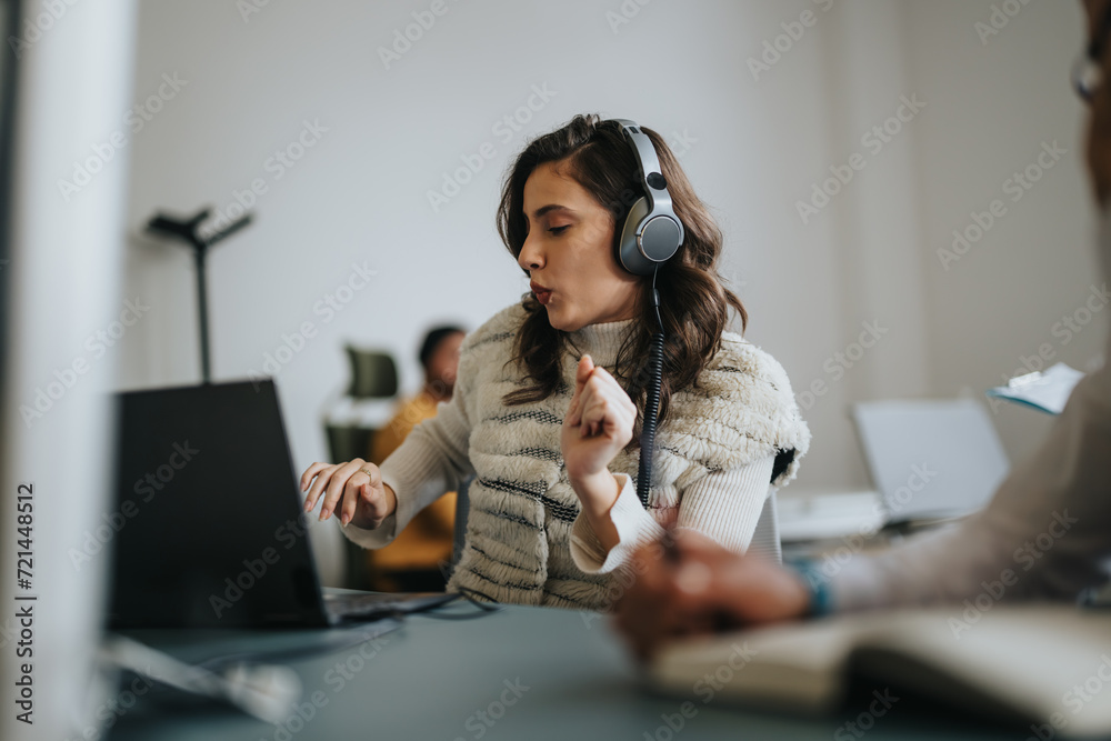 Dancing at her desk, woman adds a lively touch to the positive work ...