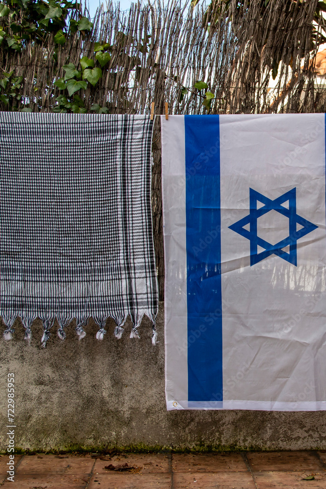 Israel flag and Palestinian scarf together lying on a rope to dry after ...