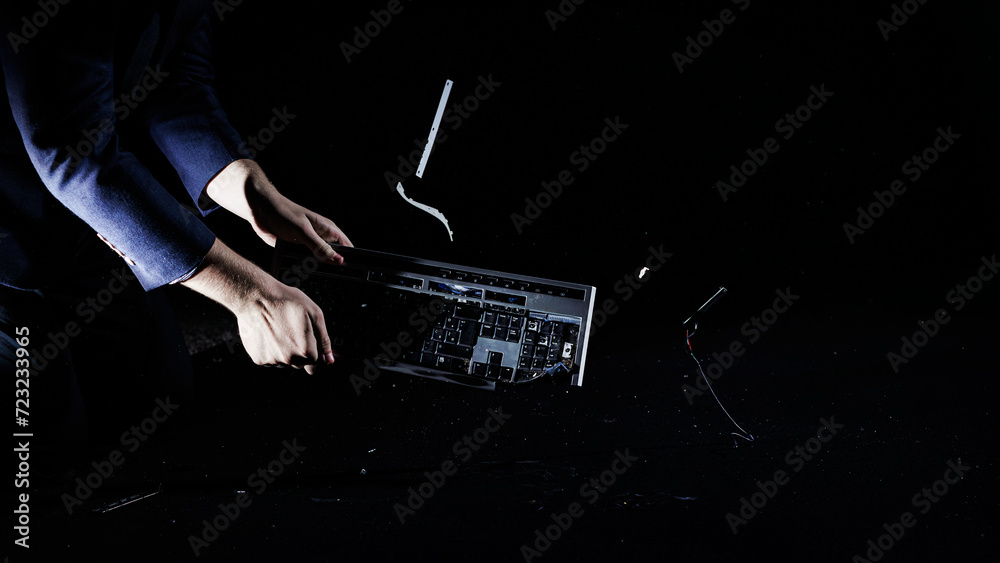 Man banging and hitting computer keyboard on a hard floor, isolated on ...