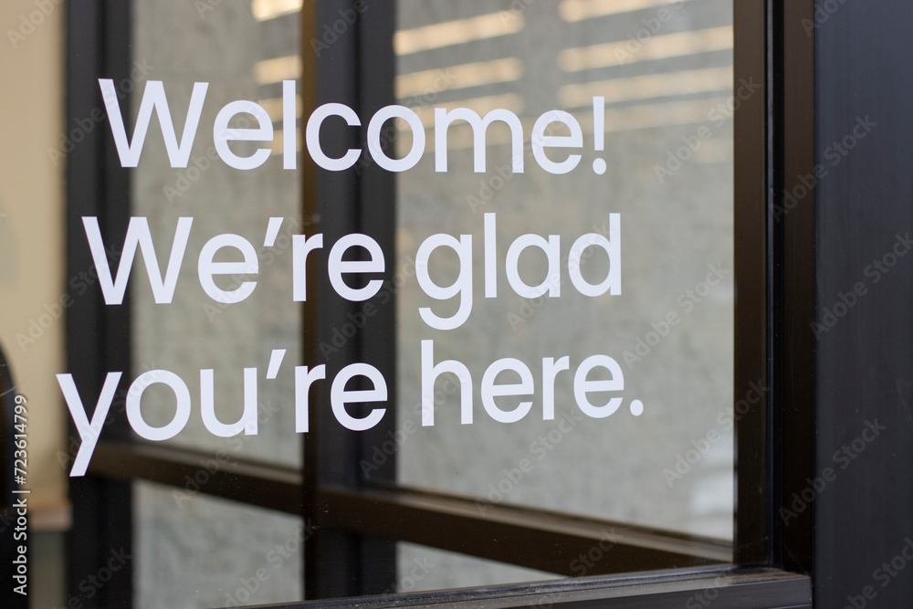 Welcome sign at the storefront. Stock Photo | Adobe Stock