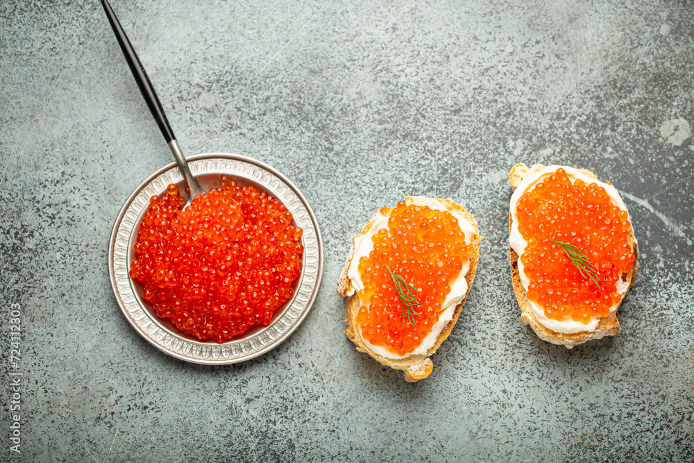Small metal plate with red salmon caviar and two caviar toasts canapé ...