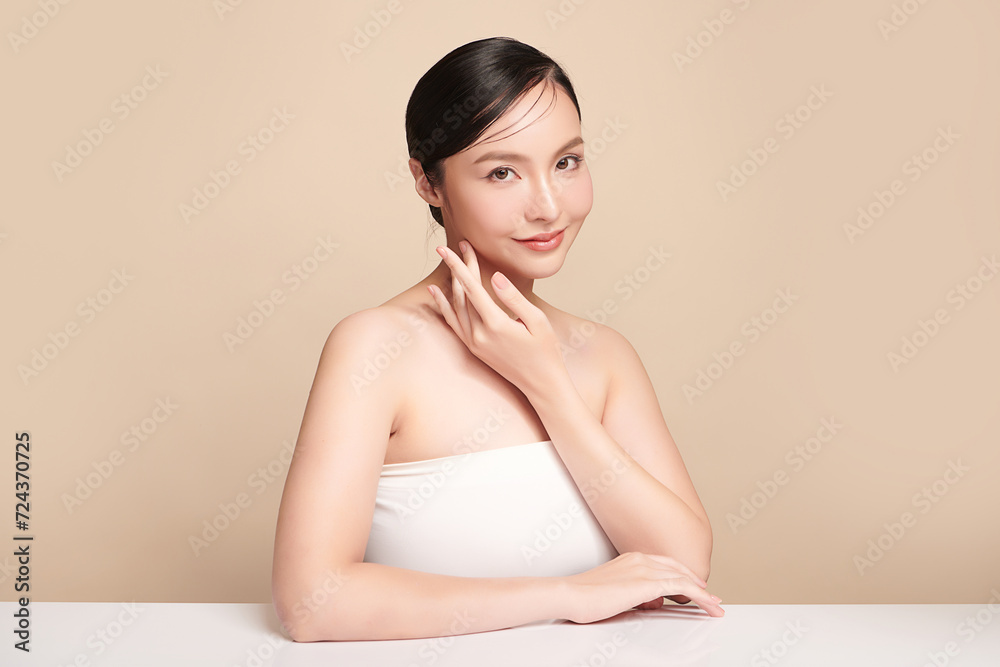 Beautiful young asian woman with clean fresh skin on beige background ...