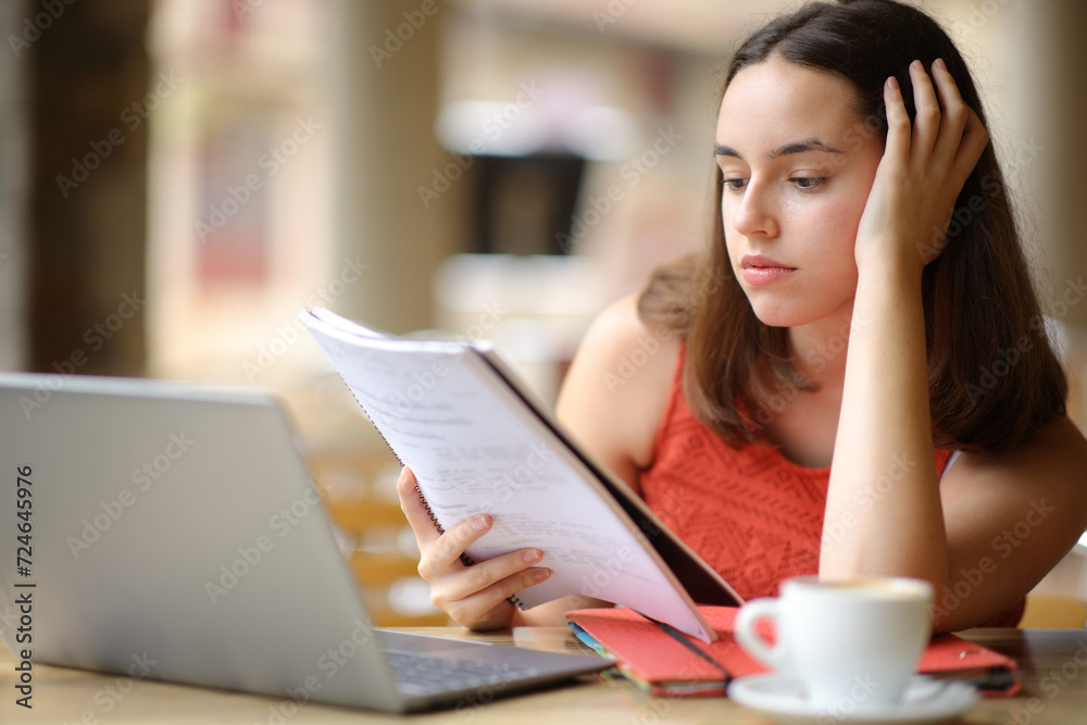 Concentrated student memorizing notes in a bar Stock Photo | Adobe Stock