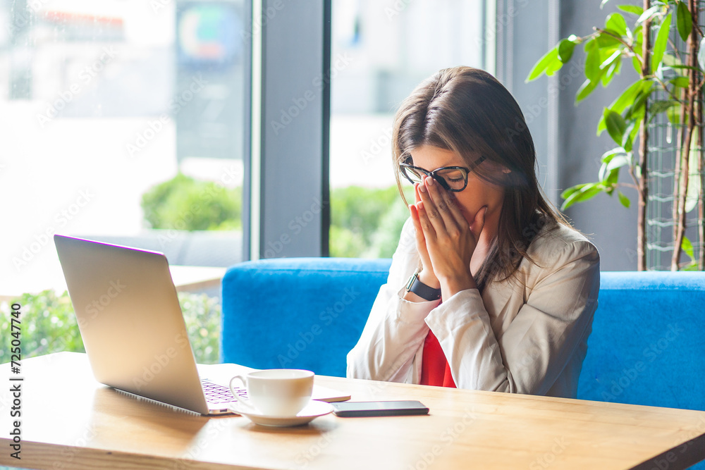 Portrait of unhappy brunette woman working on laptop crying having ...