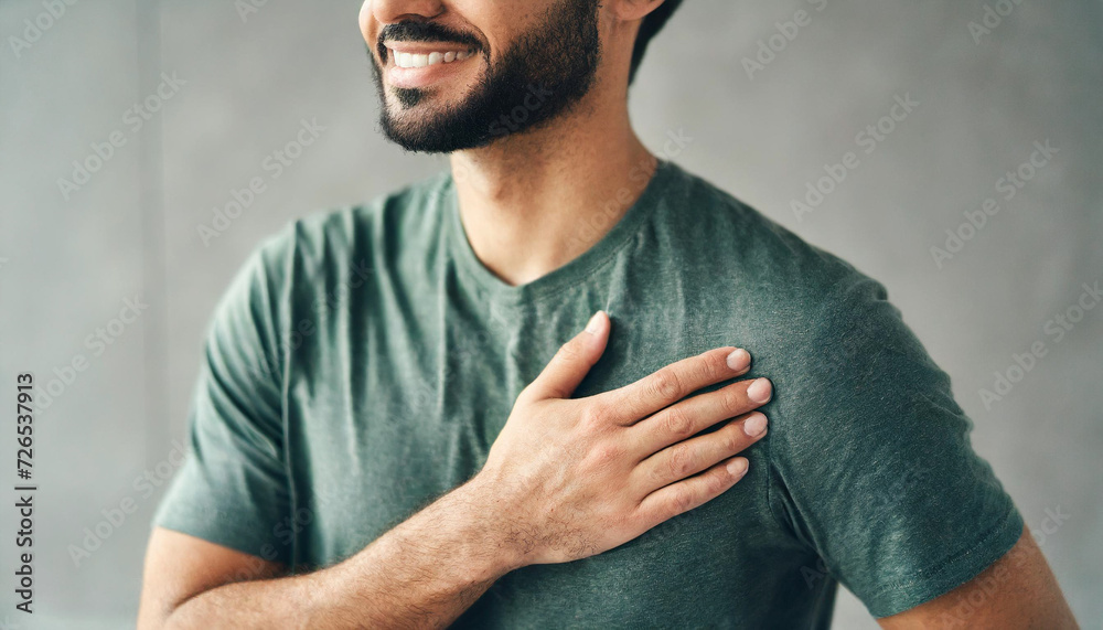 hand over chest, depicting heart attack pain, against a clean ...