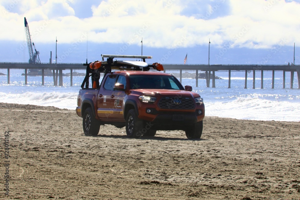 Lifeguard surveillance and rescue vehicle. Pickup truck patrolling the ...