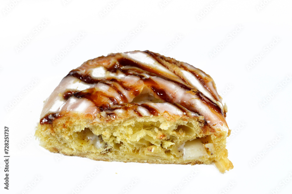 White chocolate and caramel sauce topping on a baked Danish pastry ...