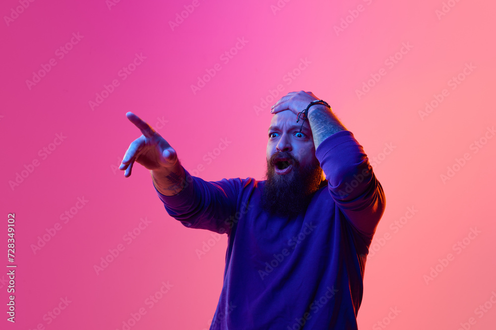 Wow. Bearded bald man in his 30s standing with wide open eyes, mouth, showing shocked face and ...