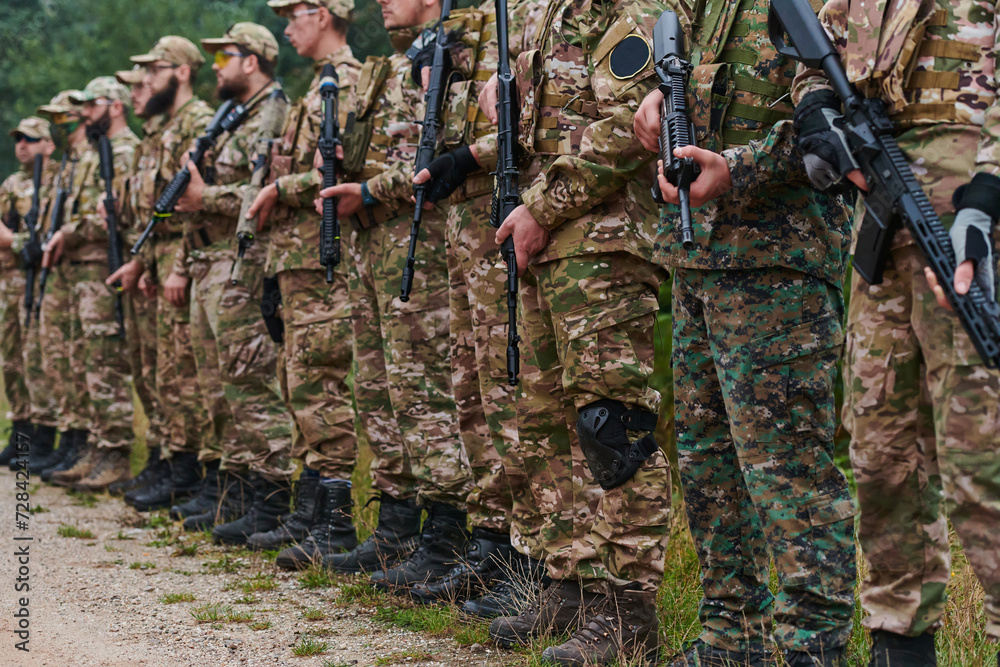 Soldier fighters standing together with guns. Group portrait of US army ...