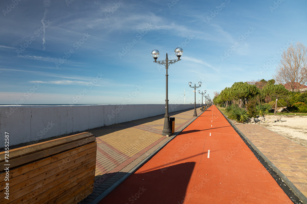 promenade of the resort town along the sea with a pedestrian and ...