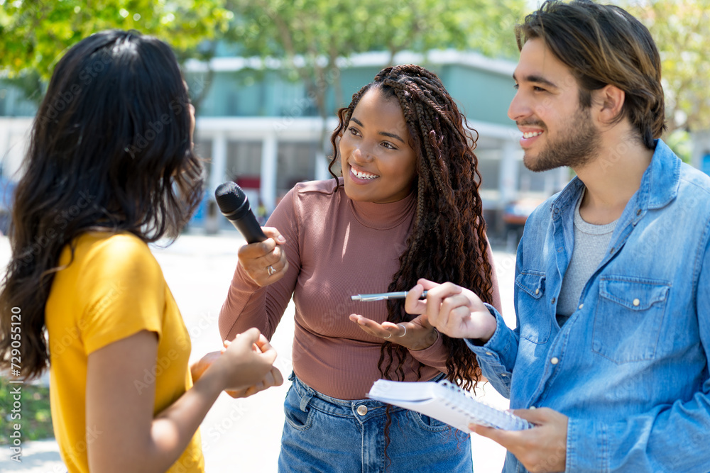 African american female journalist with latin reporter at interview ...