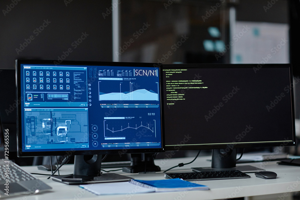 Front view background image of two computers with data charts on screen ...