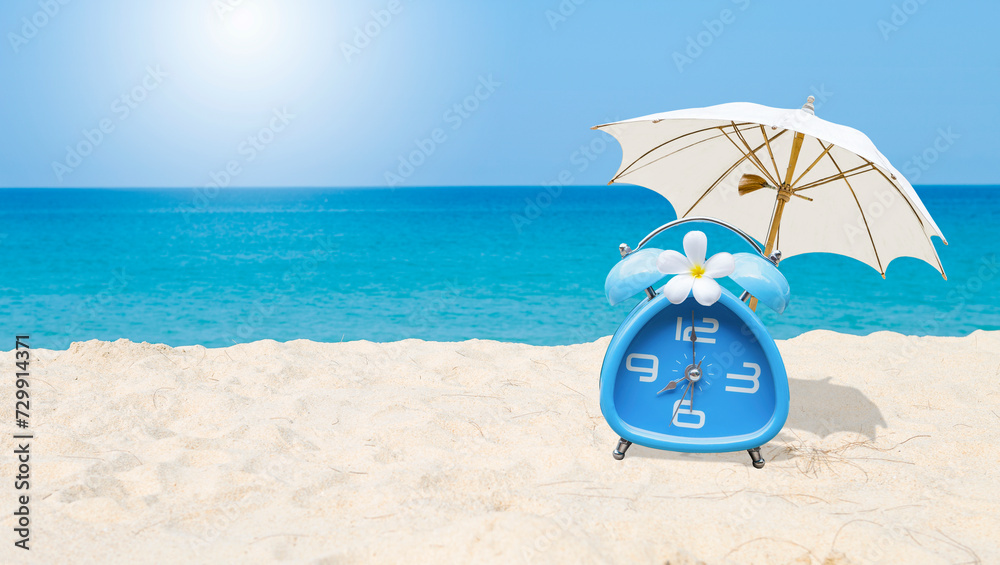 Classic style blue alarm clock with plumeria flower and white beach ...