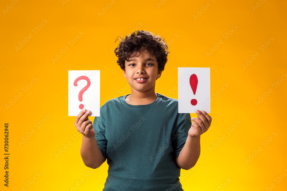 Kid boy holding question mark and exclamation point card in hand ...