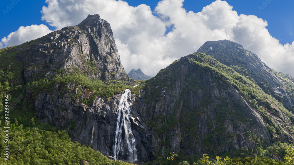 Sunlight dapples a majestic Norwegian waterfall Valefossen cascading ...