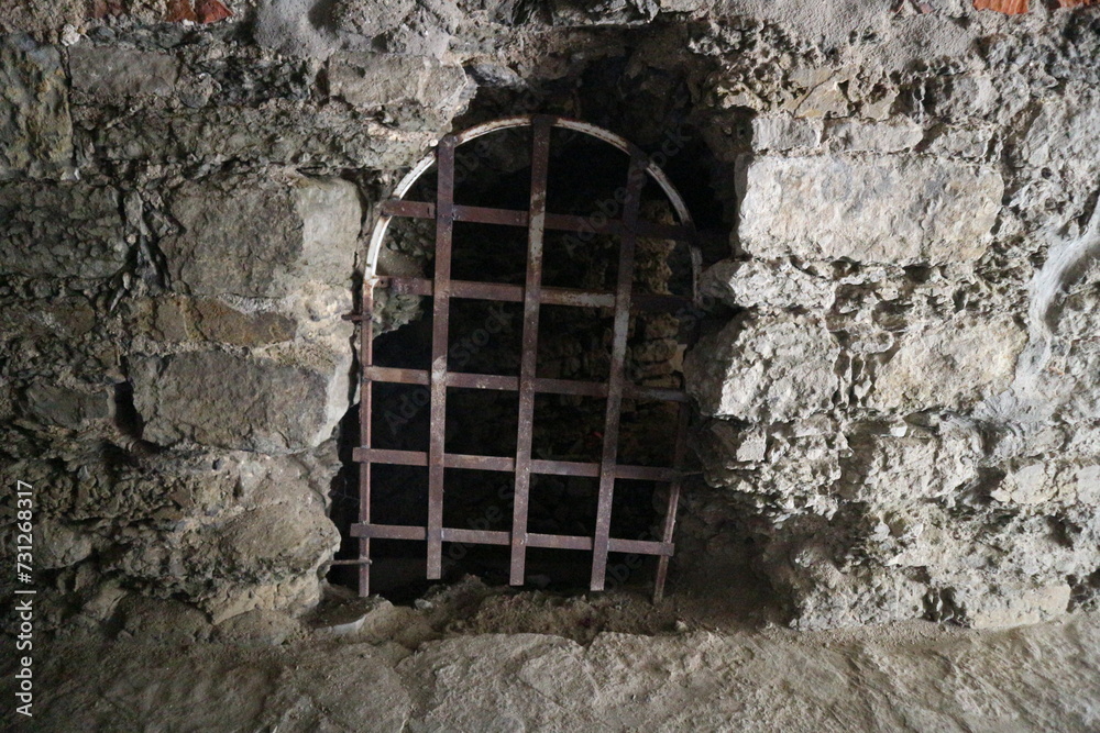 The barred window of the prison of ancient times. A window with a grill ...