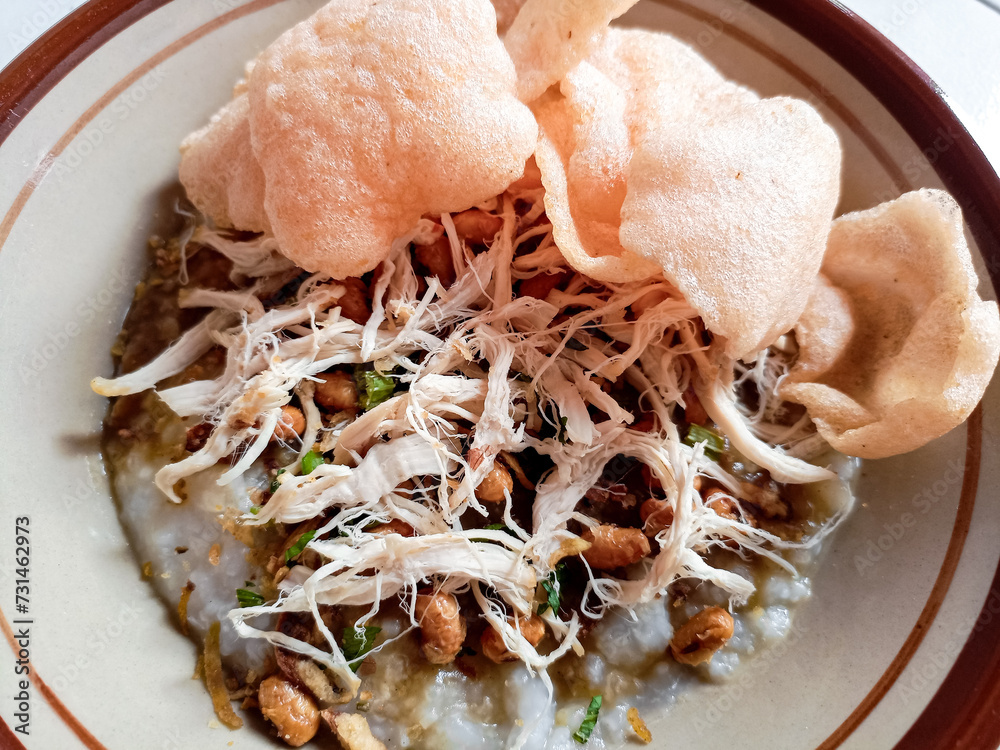 Bubur ayam or chicken congee is Chinese Indonesian rice porridge topped ...