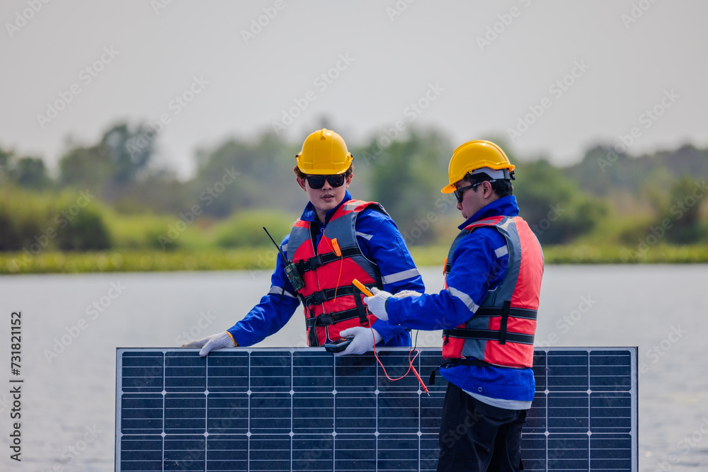 Technicians check floating solar farm wiring, polarity, and grounding ...
