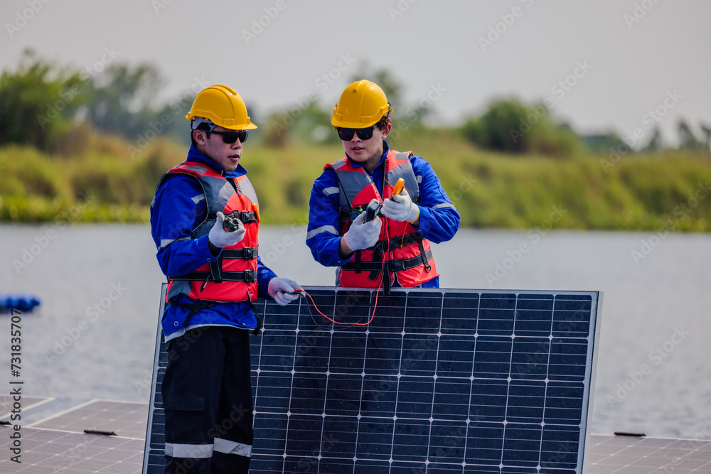 Technicians check floating solar farm wiring, polarity, and grounding ...