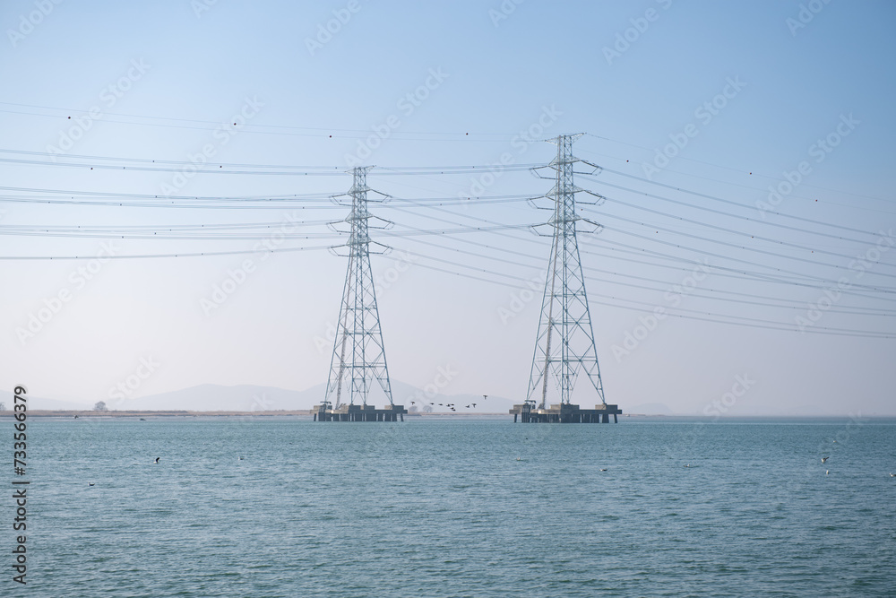 High-voltage transmission tower built on the sea where electricity ...