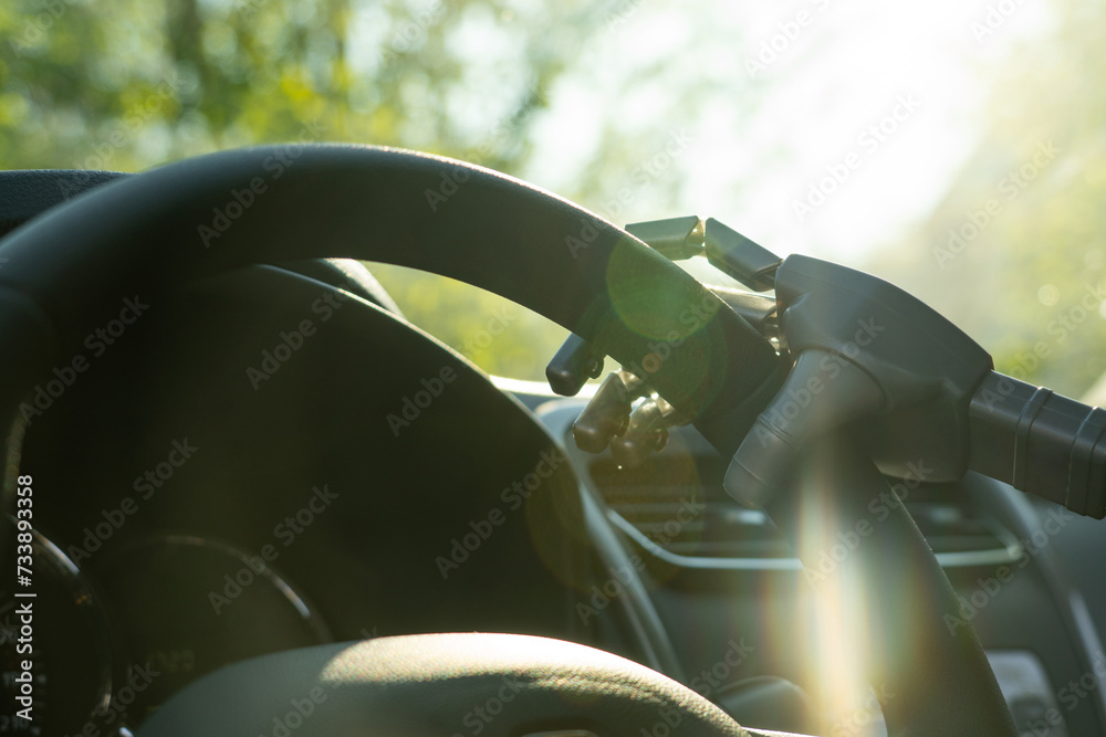 Robot arm on a steering wheel. Artificial intelligence drives a car ...