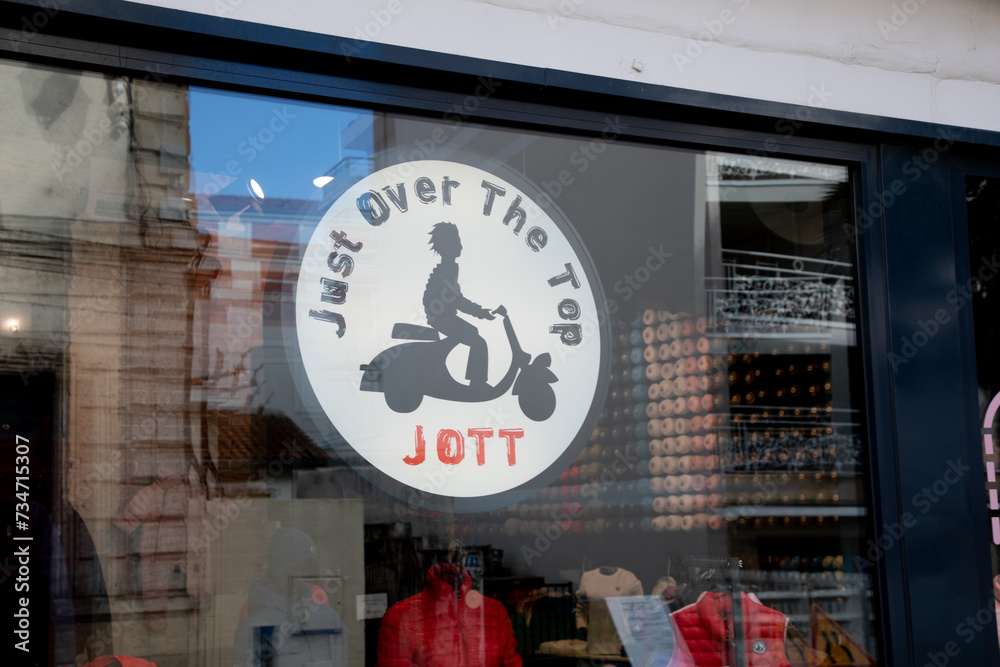 Jott sign text boutique and scooter logo brand on windows facade of ...