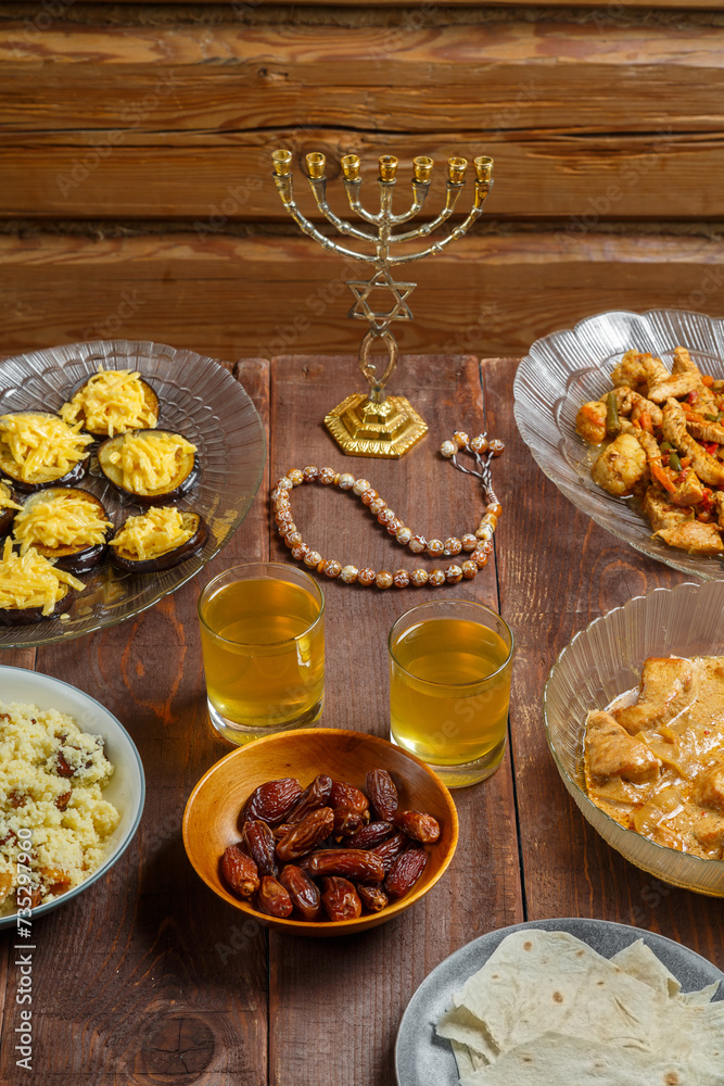 Shabbat table for a family meal with traditional holiday dishes on the ...