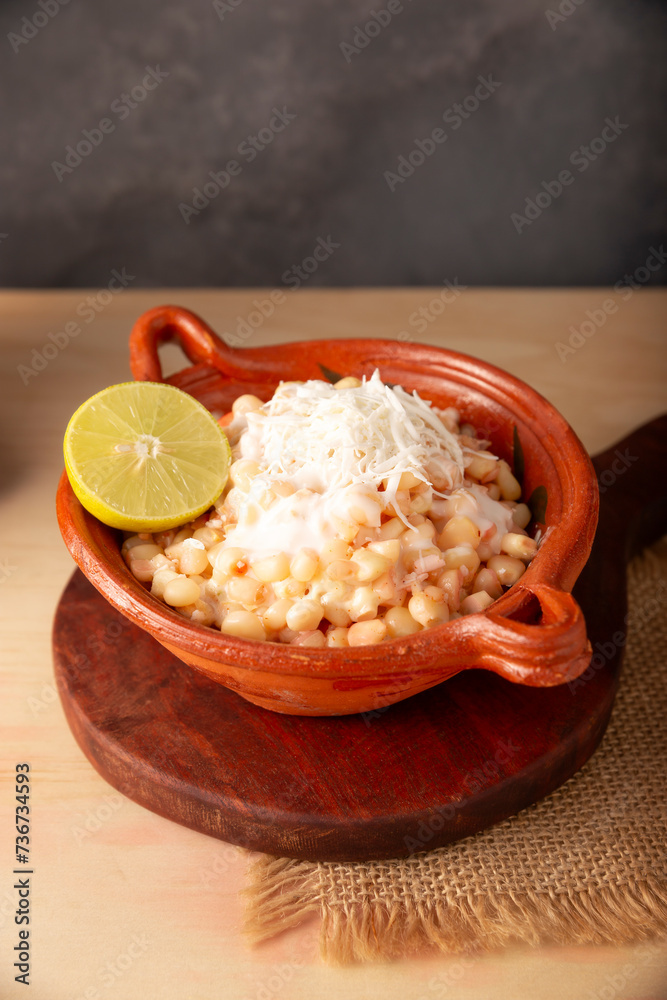 Esquites. Corn kernels cooked and served with mayo, sour cream, lemon ...
