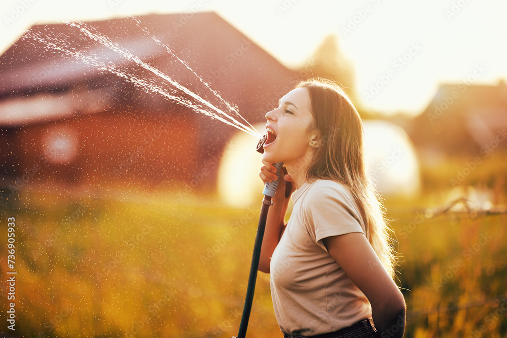 Mischievous young white woman with garden hose is depicted in statue ...