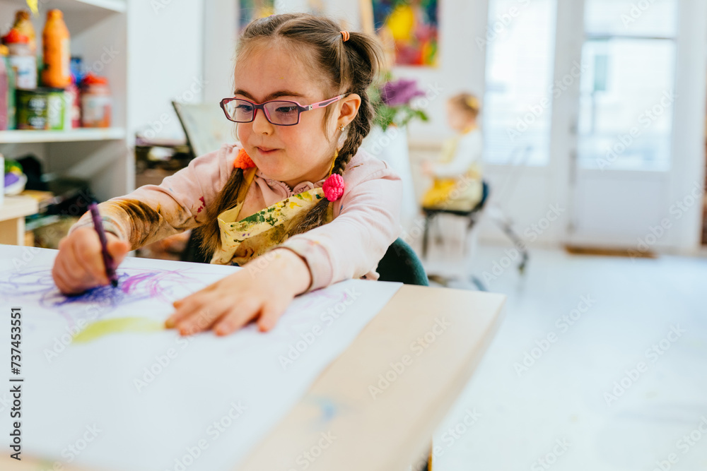 Little girl who have down syndrome in kindergarten class doing art ...
