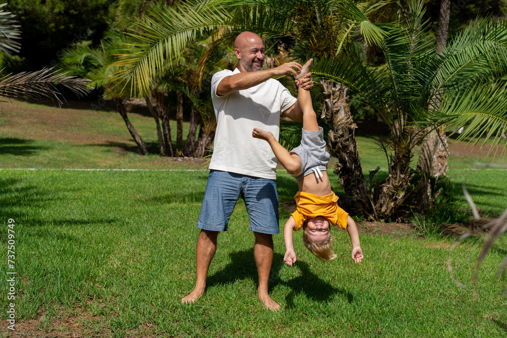 funny father playing with baby feet. . laughter therapy. father tickles ...