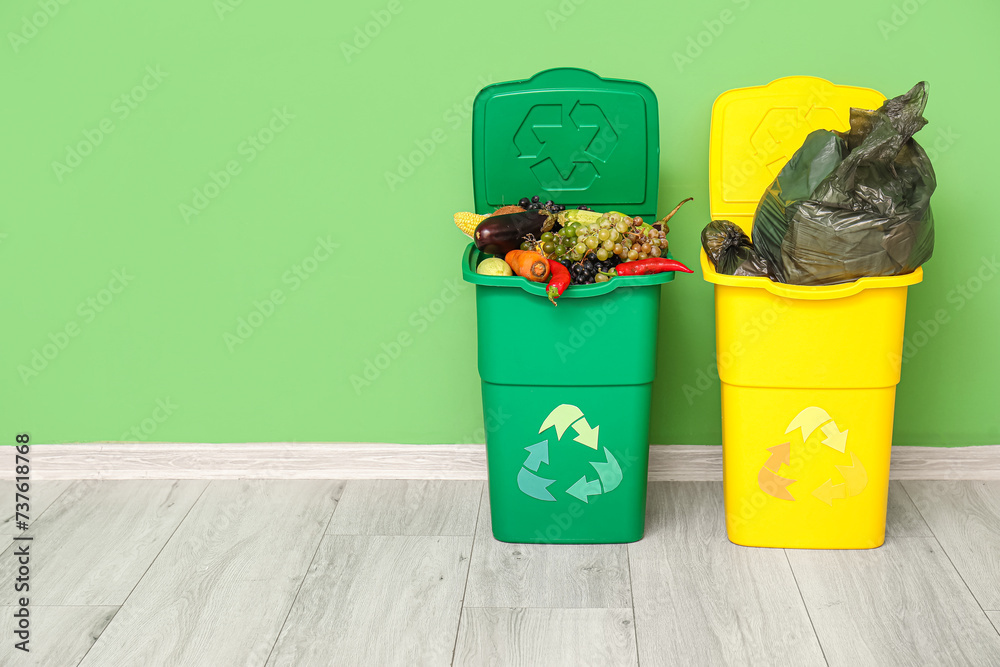 Containers for trash with food waste and full garbage bag near green ...