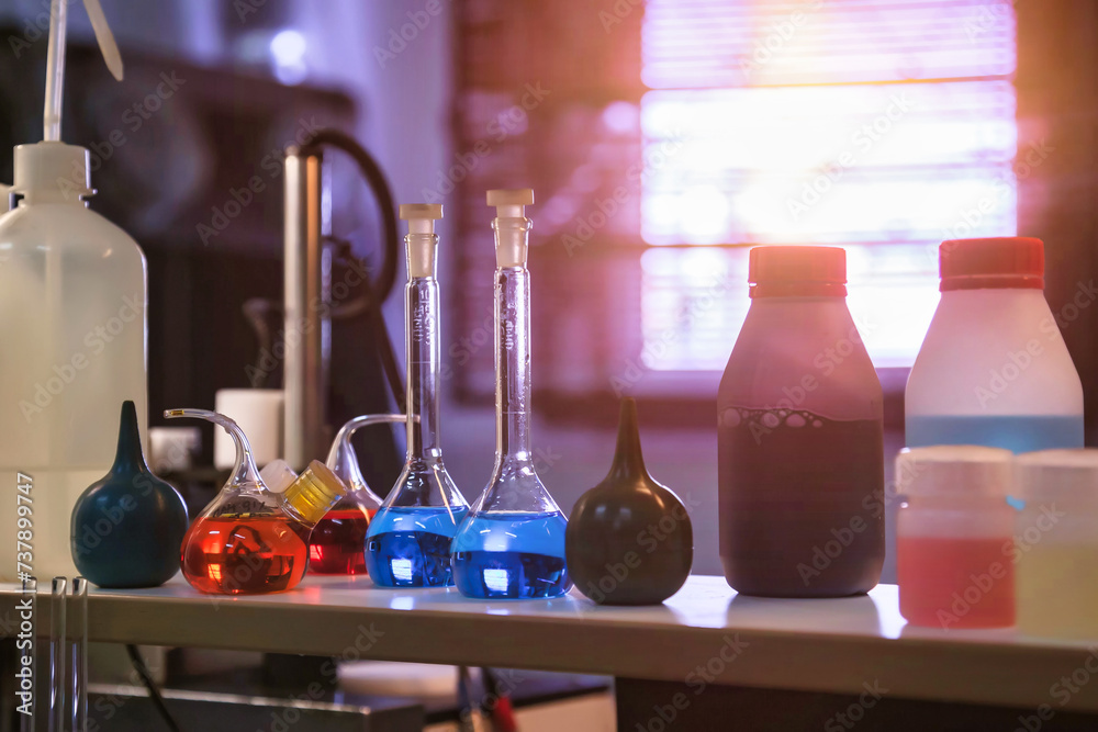Conical flasks and test tubes with acid in chemical laboratory ...