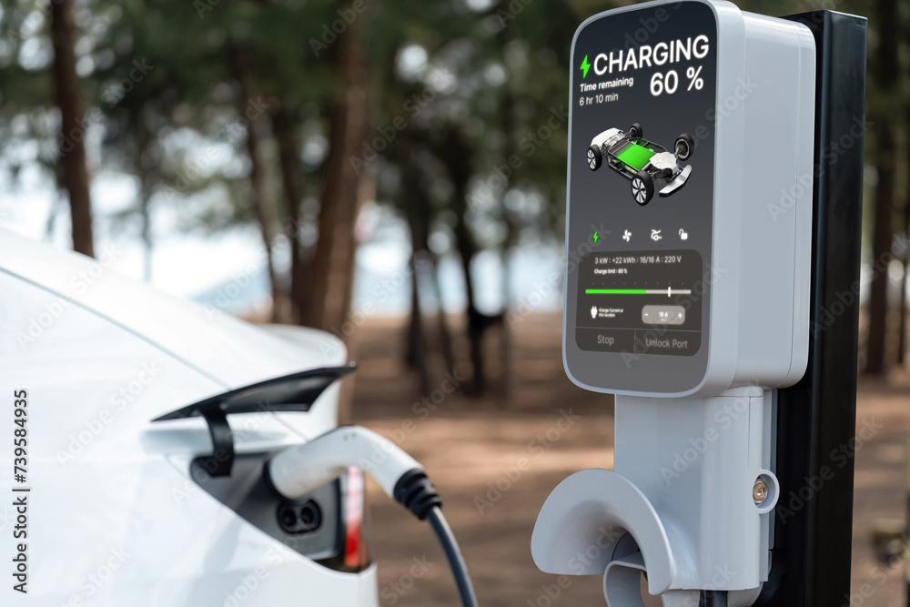 Electric car recharging battery at outdoor EV charging station for road ...