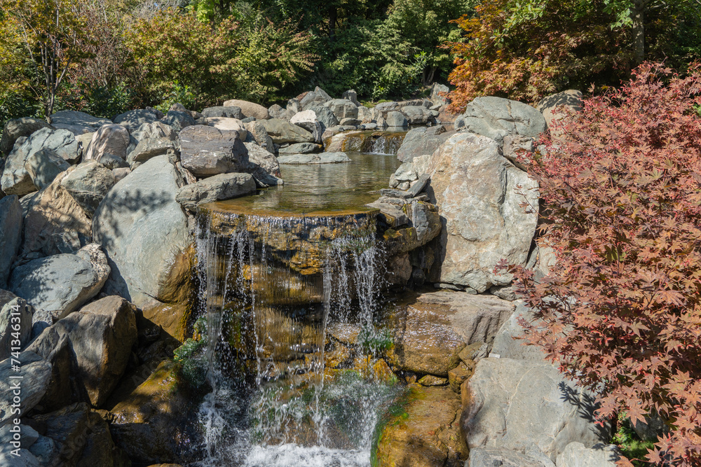 Triple waterfall in the Japanese Garden. Water falls from a height of 7 ...