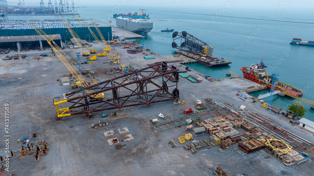 The company assembles large drilling rig structures next to the sea for ...
