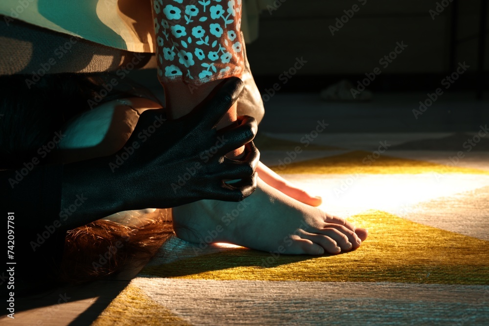 Scary monster under bed grabbing little girl by legs at home, closeup ...