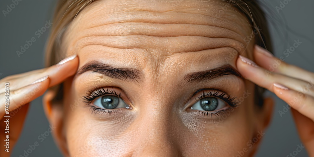 Closeup of mature womans face showing expressive wrinkles on forehead ...
