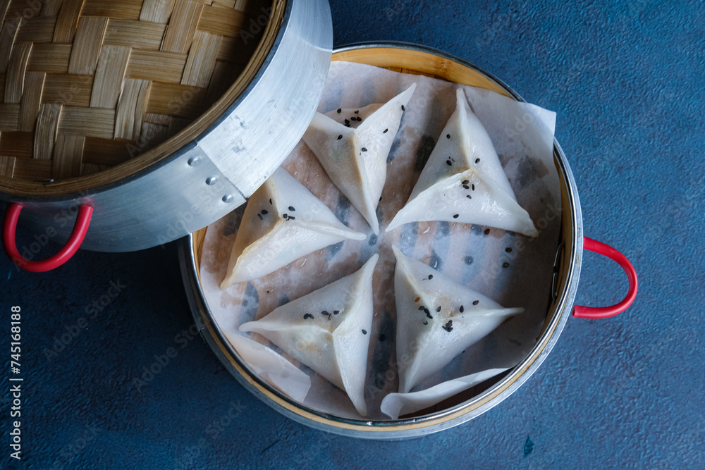 Cheesy Chicken Dumpling served on a dumpling steamer, social media post ...