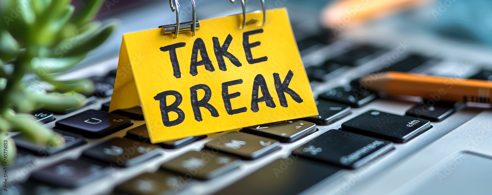Yellow sticky note with TAKE A BREAK handwritten message on a laptop ...