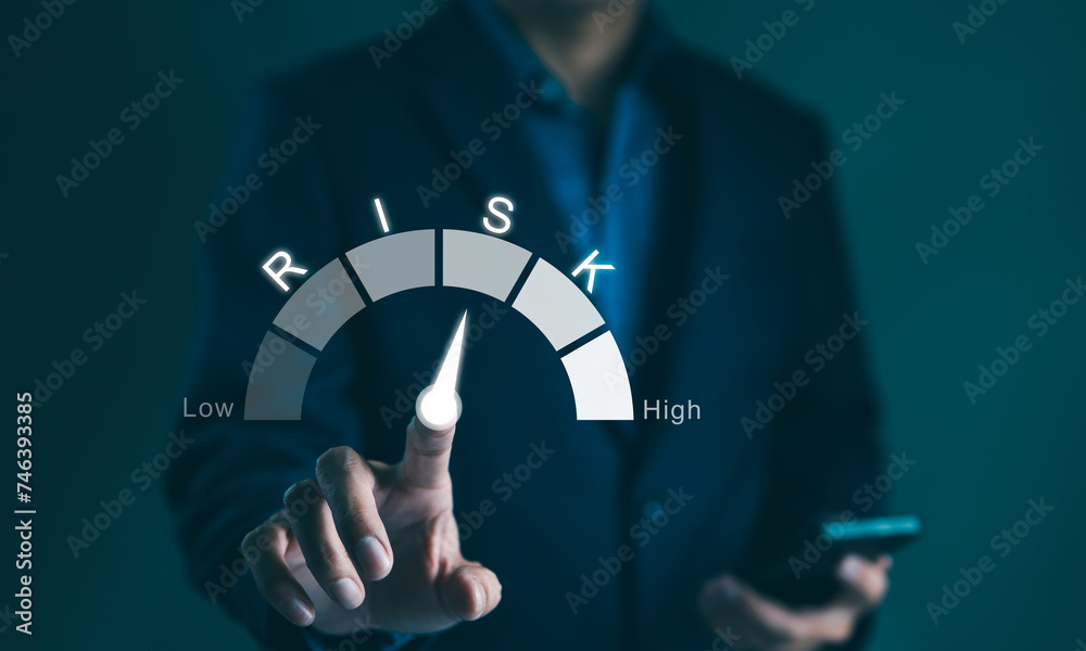 Stock-Foto „Risk management concept. Businessman touching risk level ...